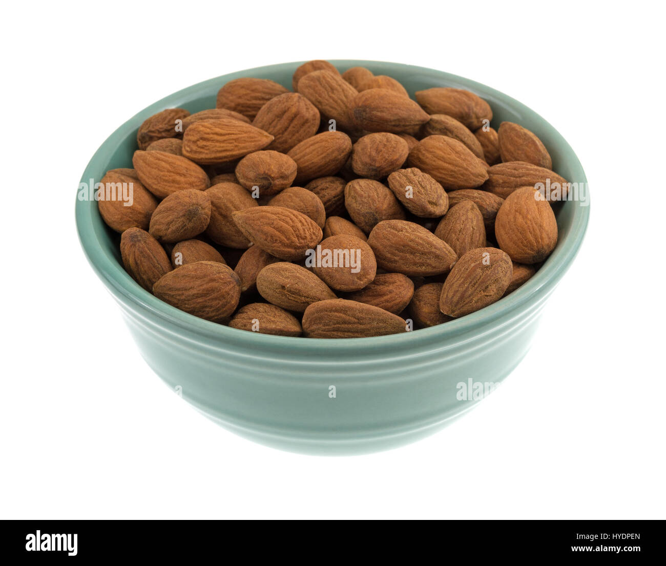 A bowl filled with raw natural almonds isolated on a white background ...