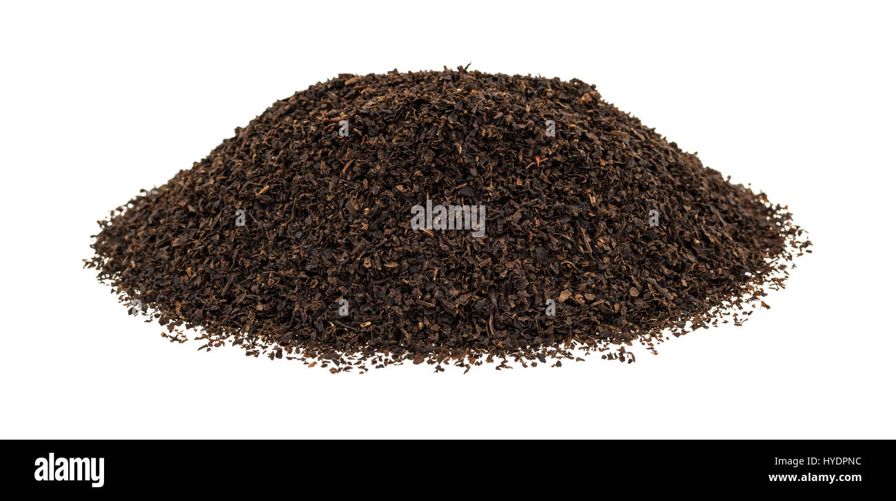 A small pile of loose leaf black tea isolated on a white background ...