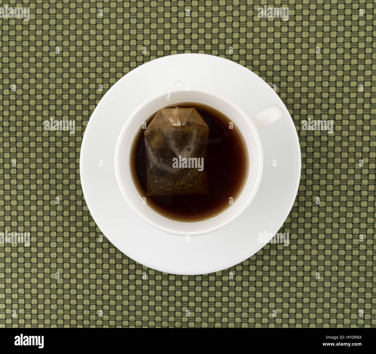 Top view of a cup and saucer of decaffeinated black tea with a tea bag ...