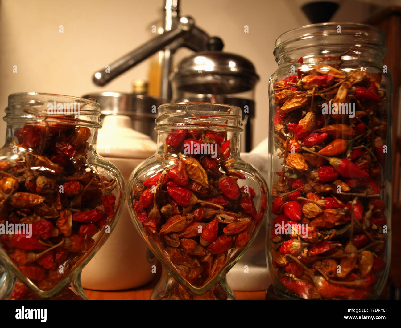 Red bird's eye chilis drying in jars in traditional Greek kitchen Stock ...