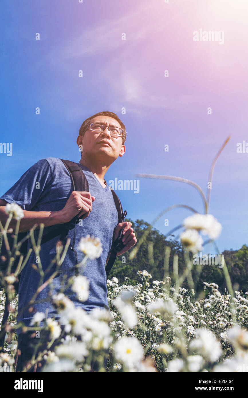 Asia man backpack travel in nature. Soft flare sunlight Stock Photo - Alamy