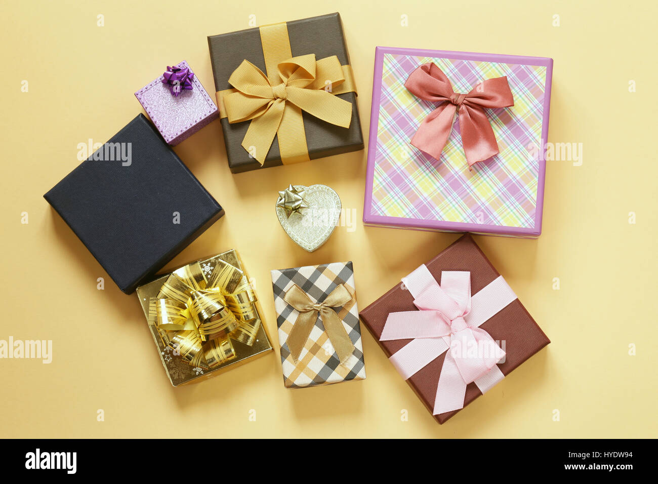 A lot of gift boxes with bows on a beige background Stock Photo - Alamy