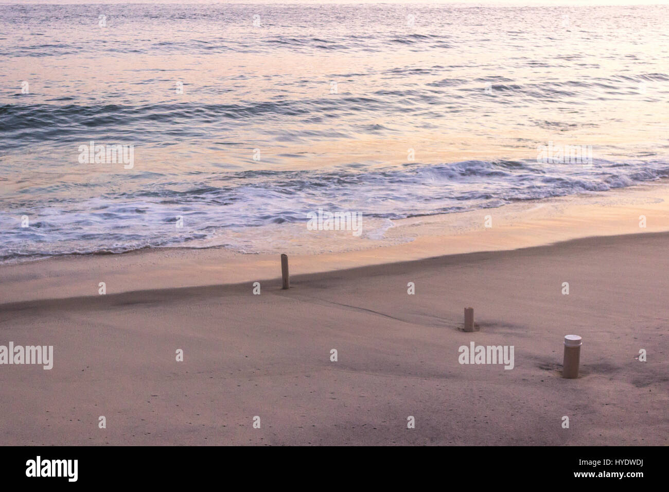 Detail of sea waves and sand illuminated by sunset light Stock Photo ...