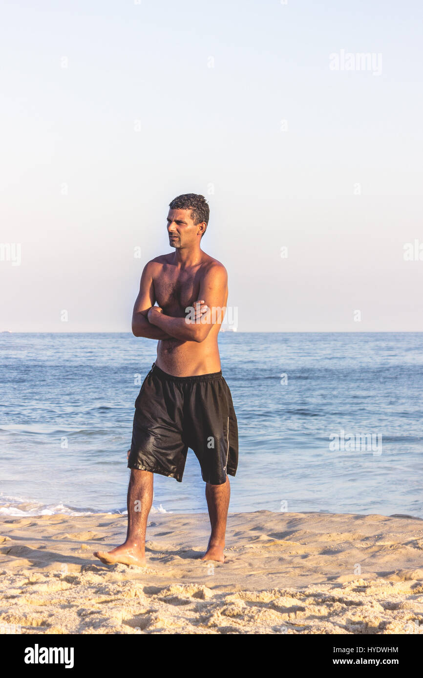 Brazil, Rio de Janeiro : Man on Ipanema beach illuminated by the sunset ...