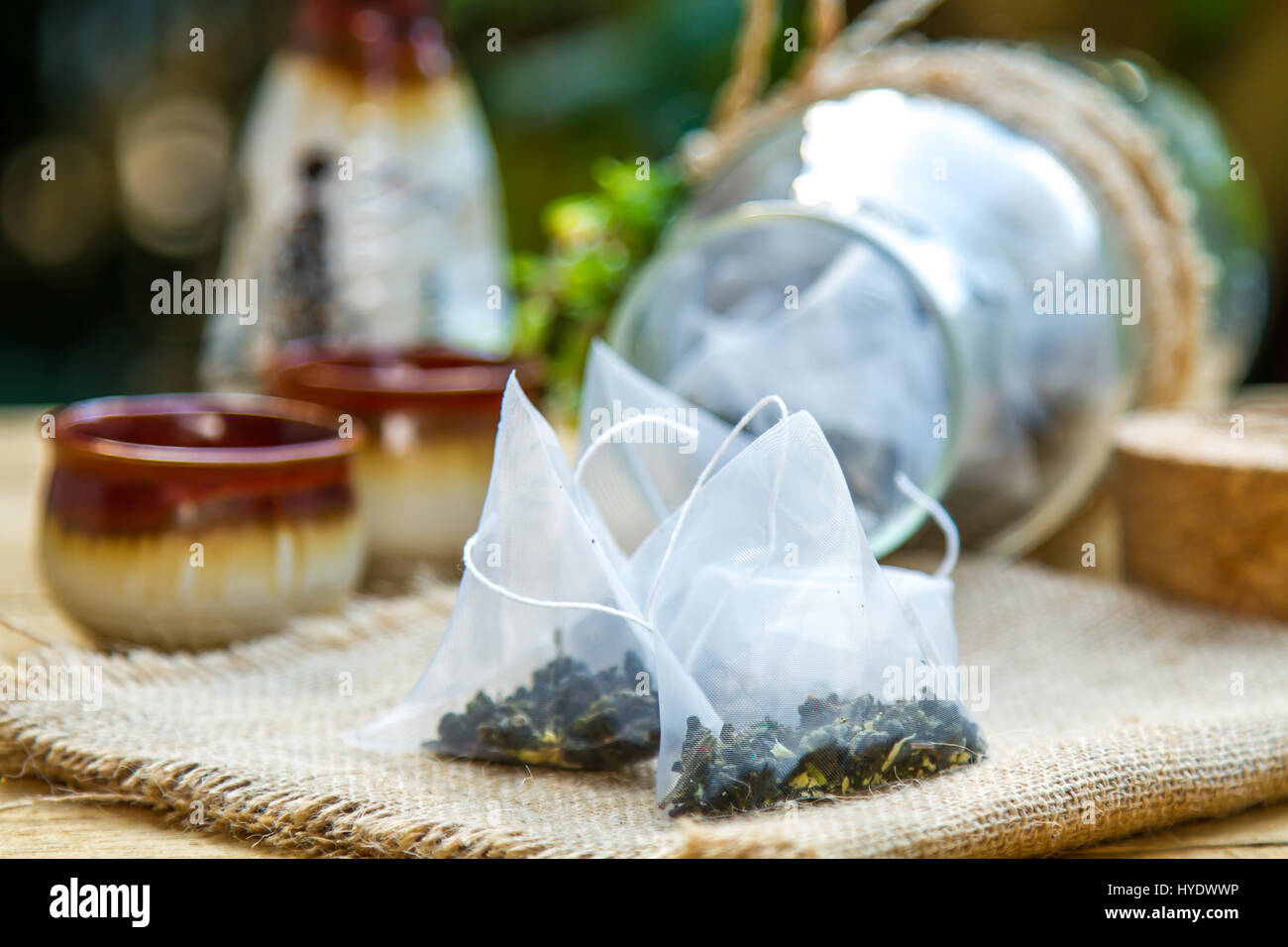 Dry tea leave in package shot close up on hemp sack on wood table Stock ...