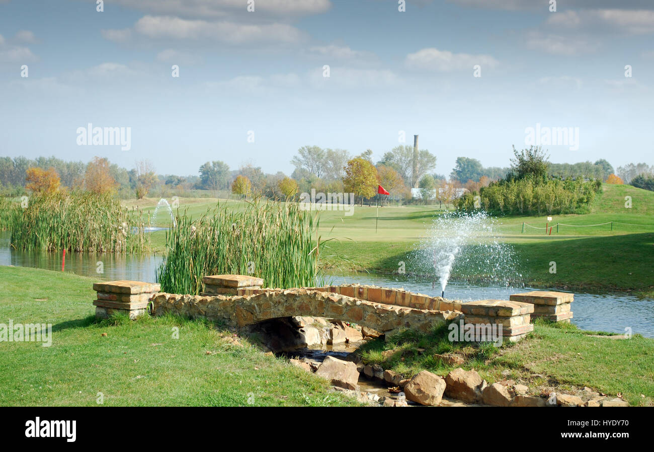 golf course with little stone bridge Stock Photo - Alamy