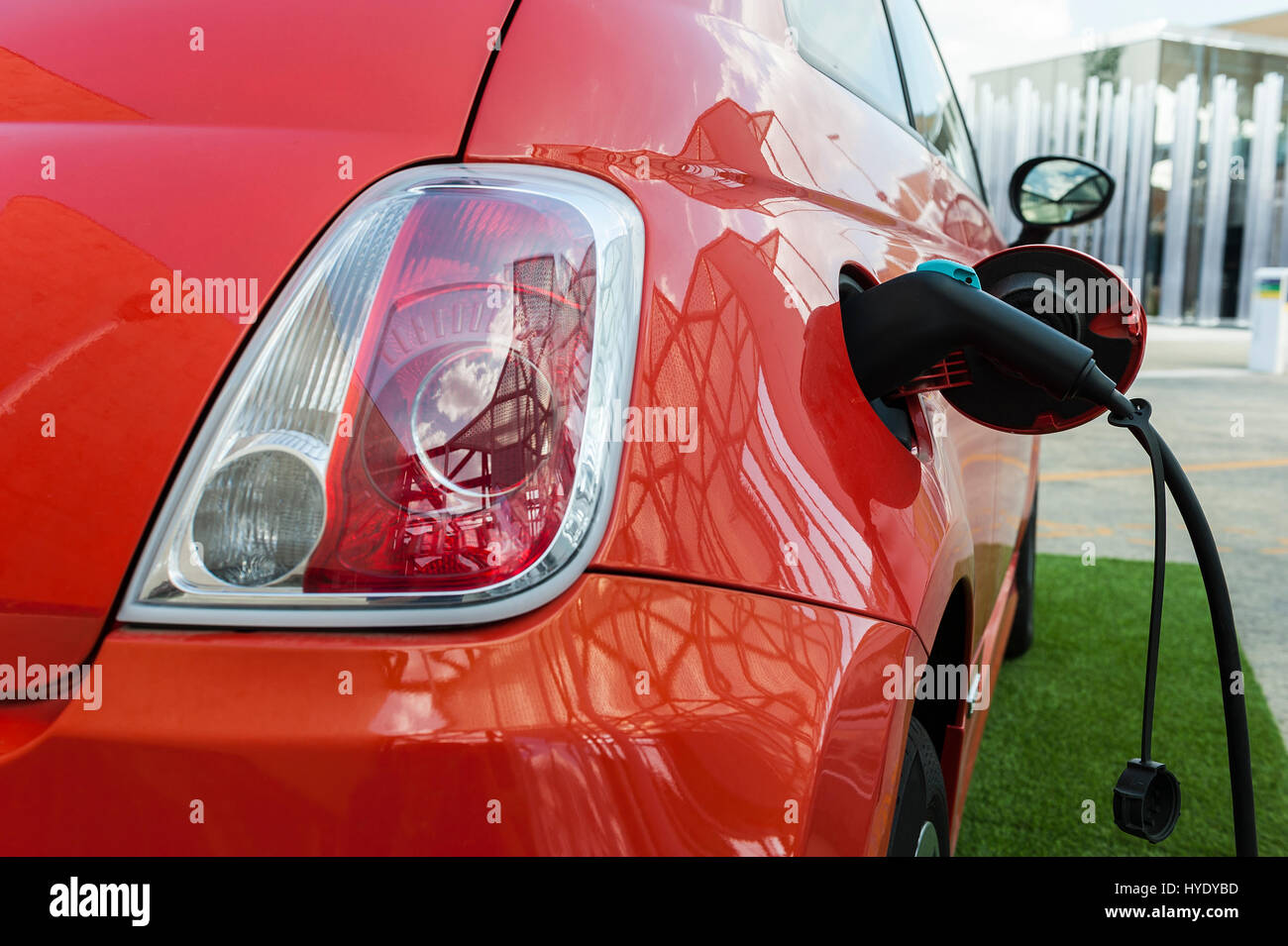 Electric red car in a charging station Stock Photo - Alamy