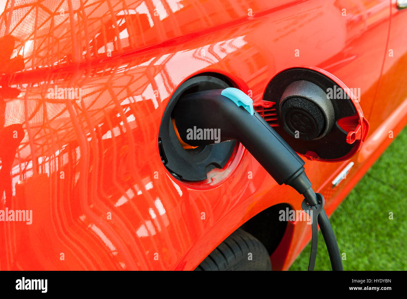 Electric red car in a charging station Stock Photo - Alamy