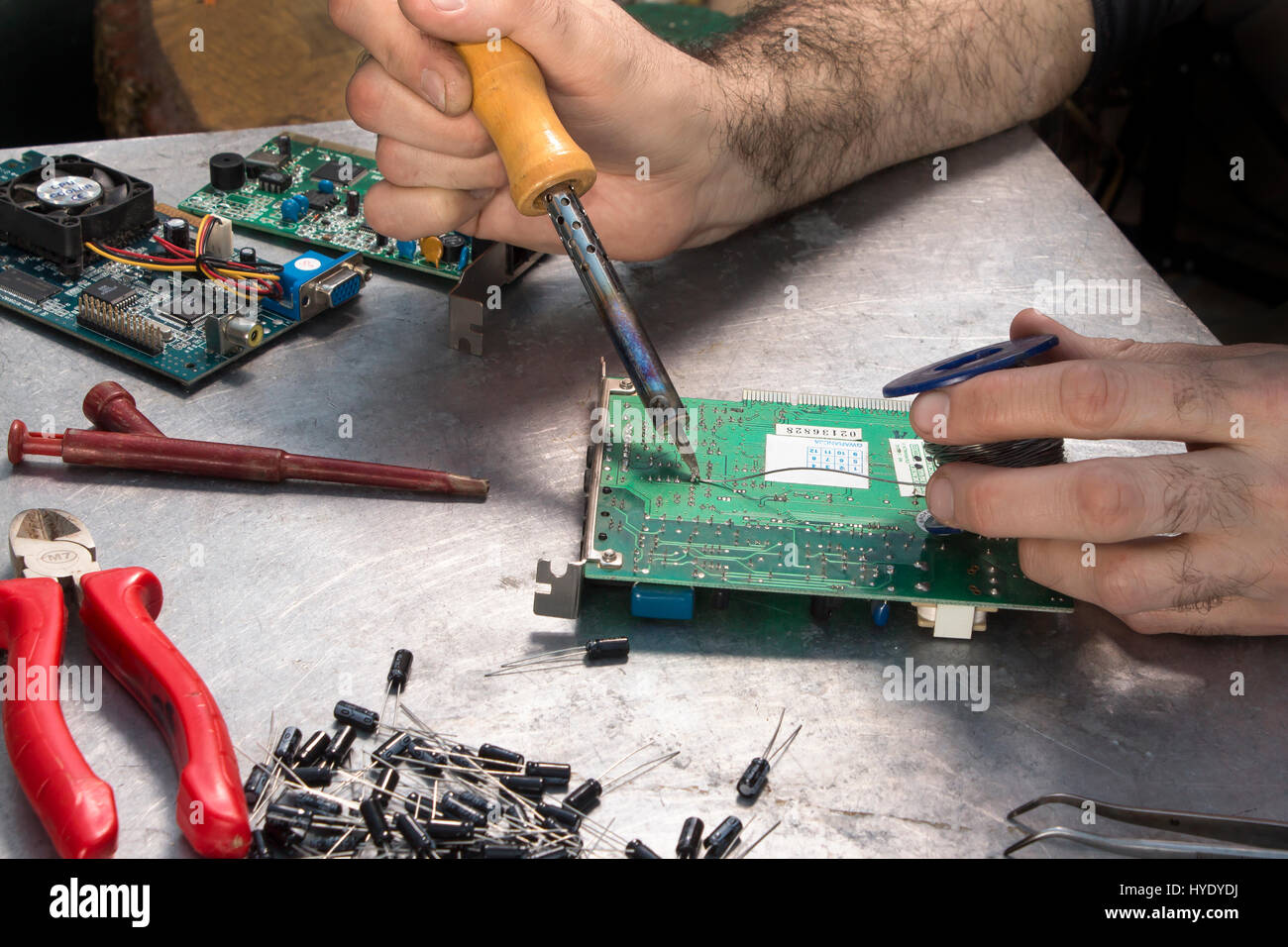 Solder soldering solder integrated circuit. Hand of a soldering soldier ...