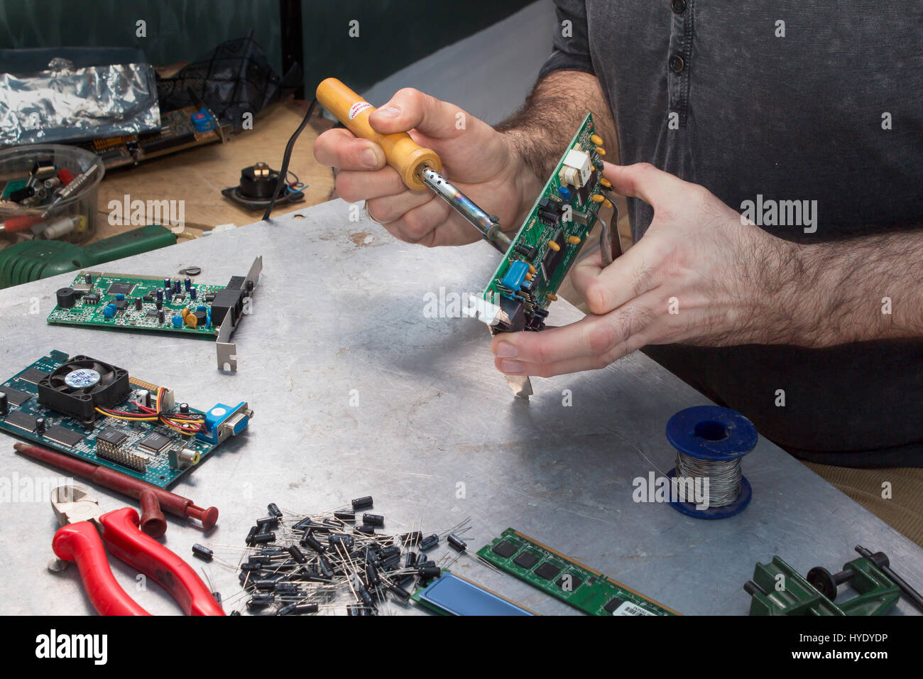 Solder soldering solder integrated circuit. Hand of a soldering soldier ...