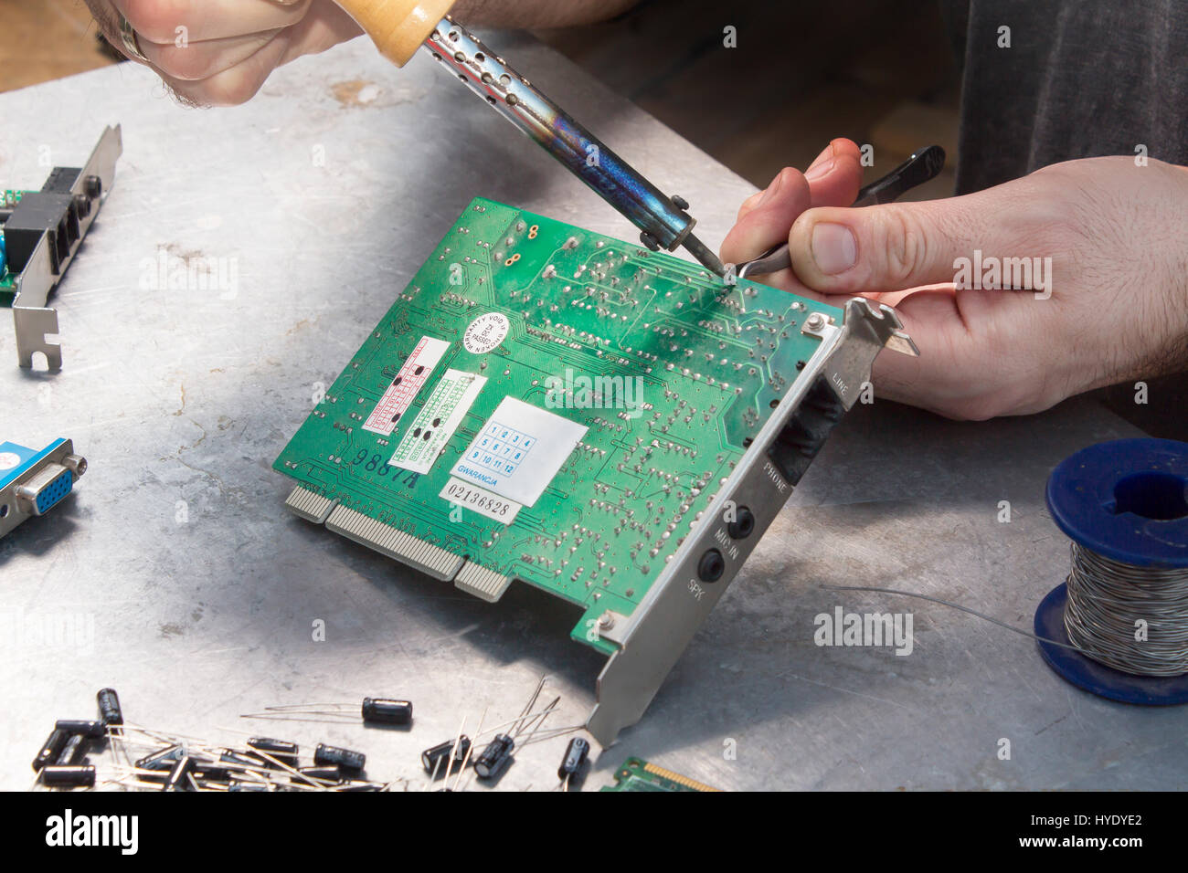 Solder soldering solder integrated circuit. Hand of a soldering soldier ...