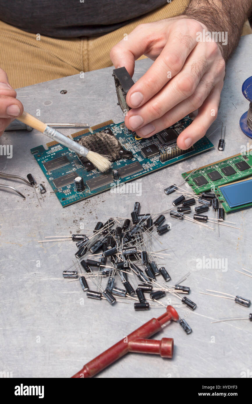 Repair the graphics card. Unscrewing the cooling fan. Service on a ...