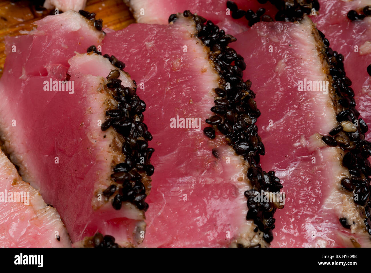 seared tuna fish sliced on cutting board Stock Photo - Alamy