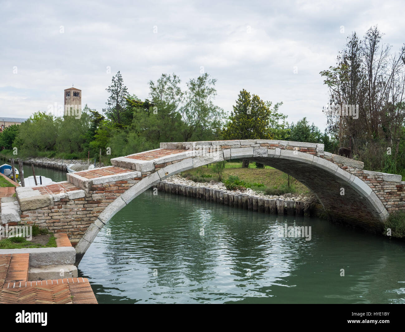 Ponte del Diavolo bridge (Devil's bridge) over canal on the island of Torcello, the oldest ...