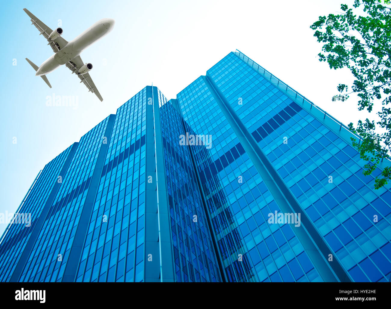 airplane with modern building. Jet over City Stock Photo - Alamy