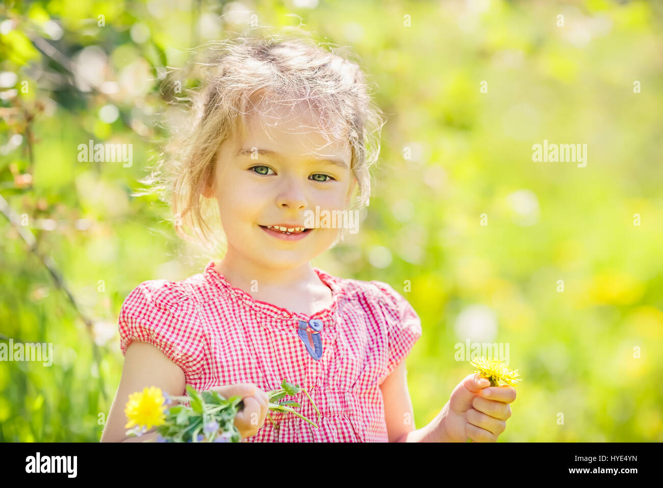 Happy little girl in spring sunny park Stock Photo - Alamy