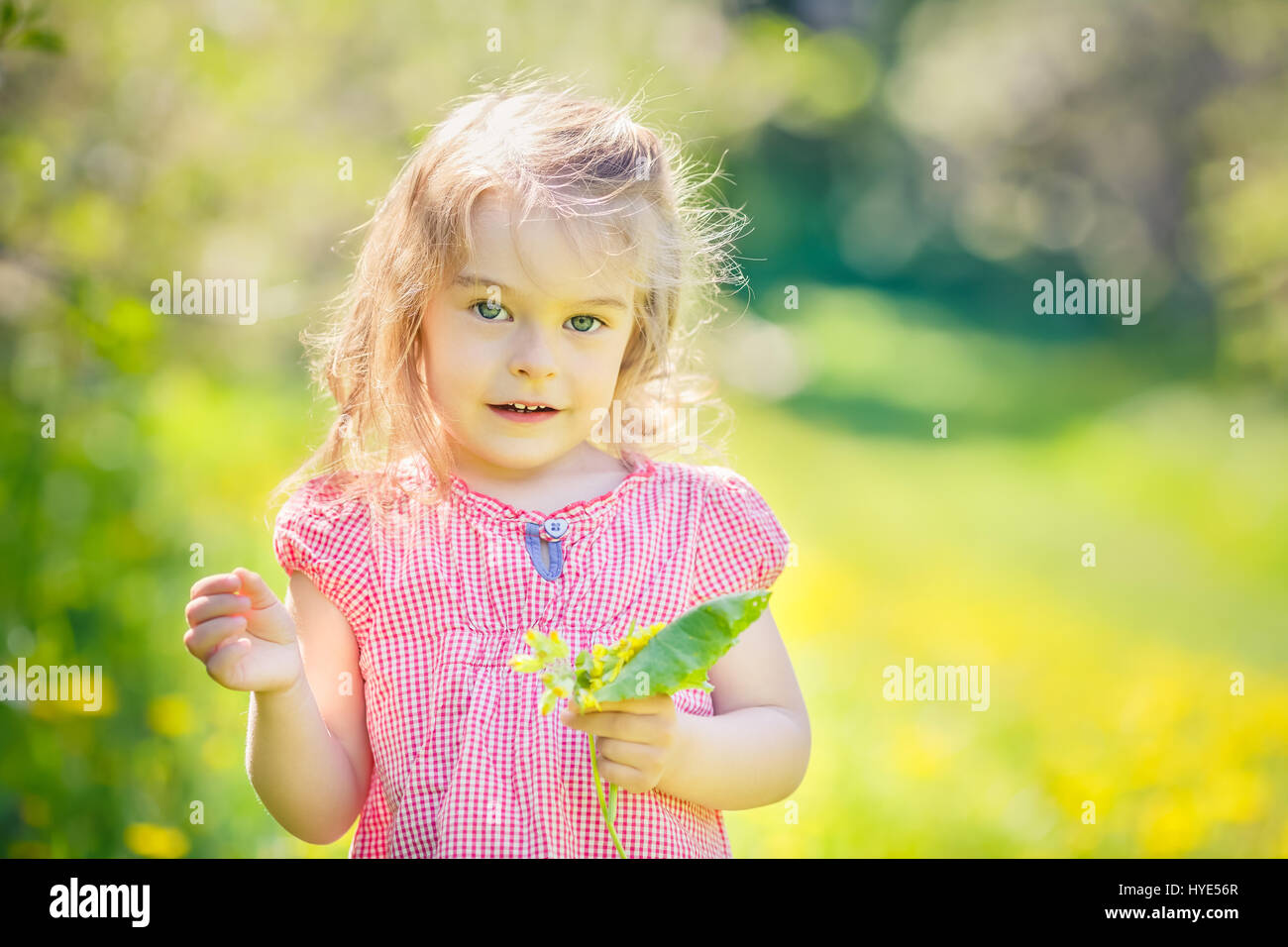 Happy little girl in spring sunny park Stock Photo - Alamy
