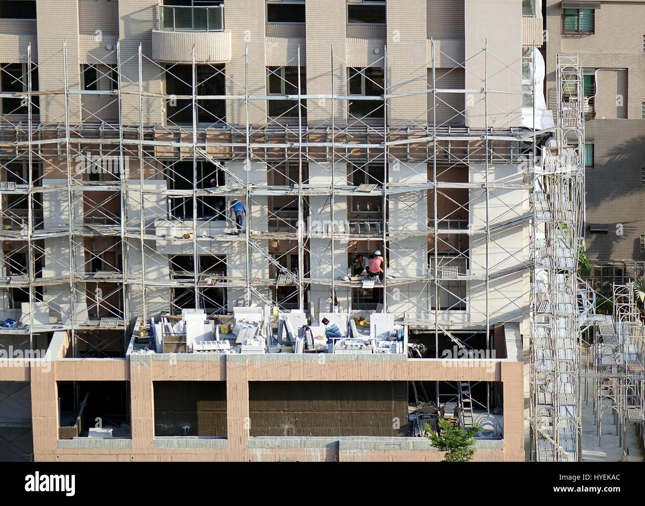 KAOHSIUNG, TAIWAN -- APRIL 18, 2015: Construction workers are working ...