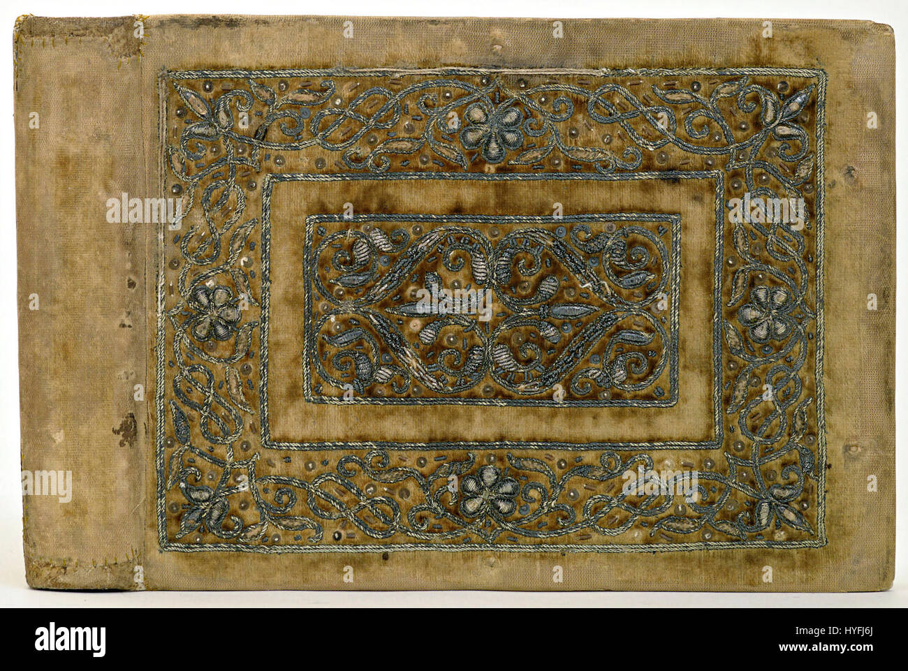 A velvet band in light brown featuring silver thread, identified as ...