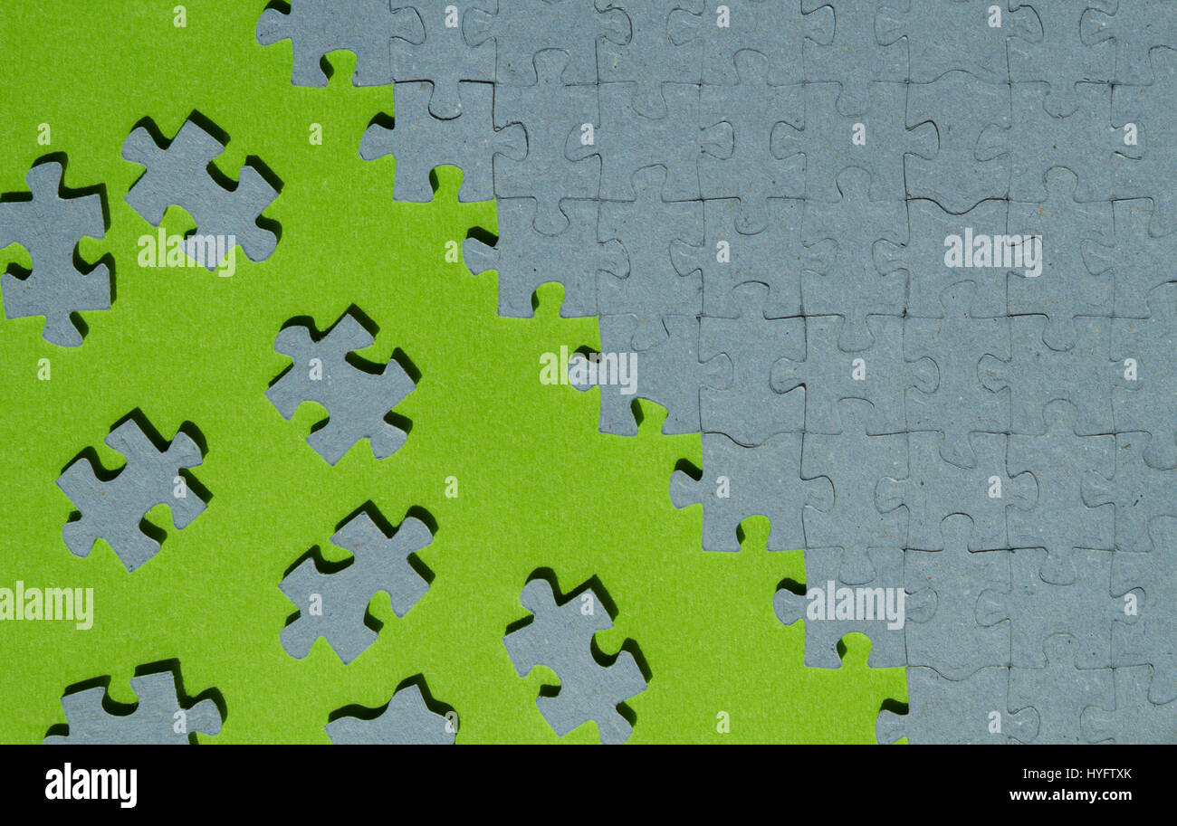 jigsaw puzzle piece cut out on green background with copy space ...