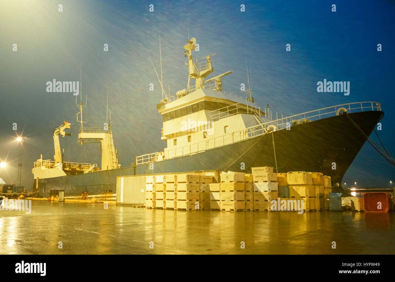 Fishing trawler ship at dock by night in drizzling rain Stock Photo - Alamy
