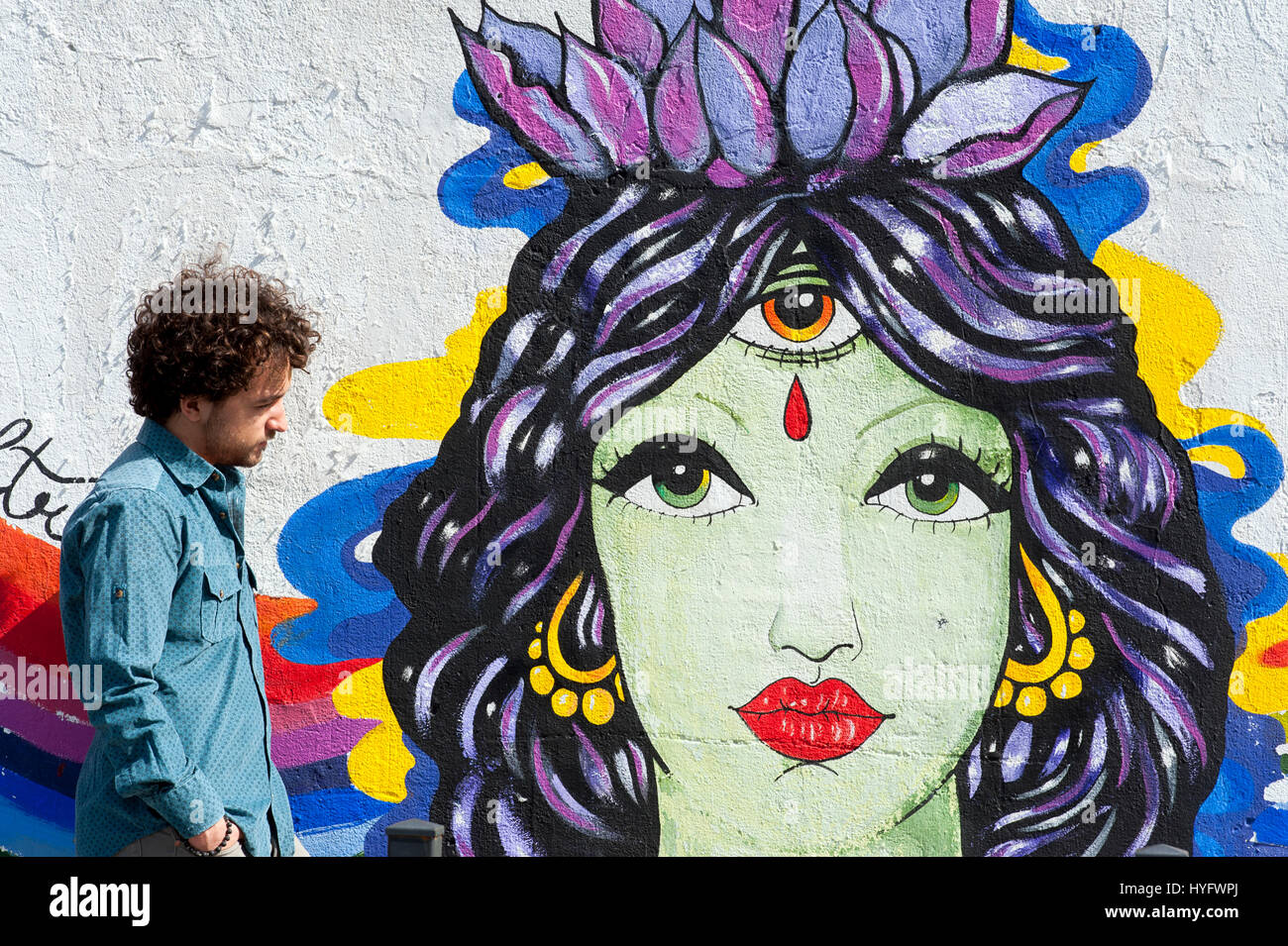 A boy observes mural in the Roman neighbourhood Primavalle. Rome. Italy ...