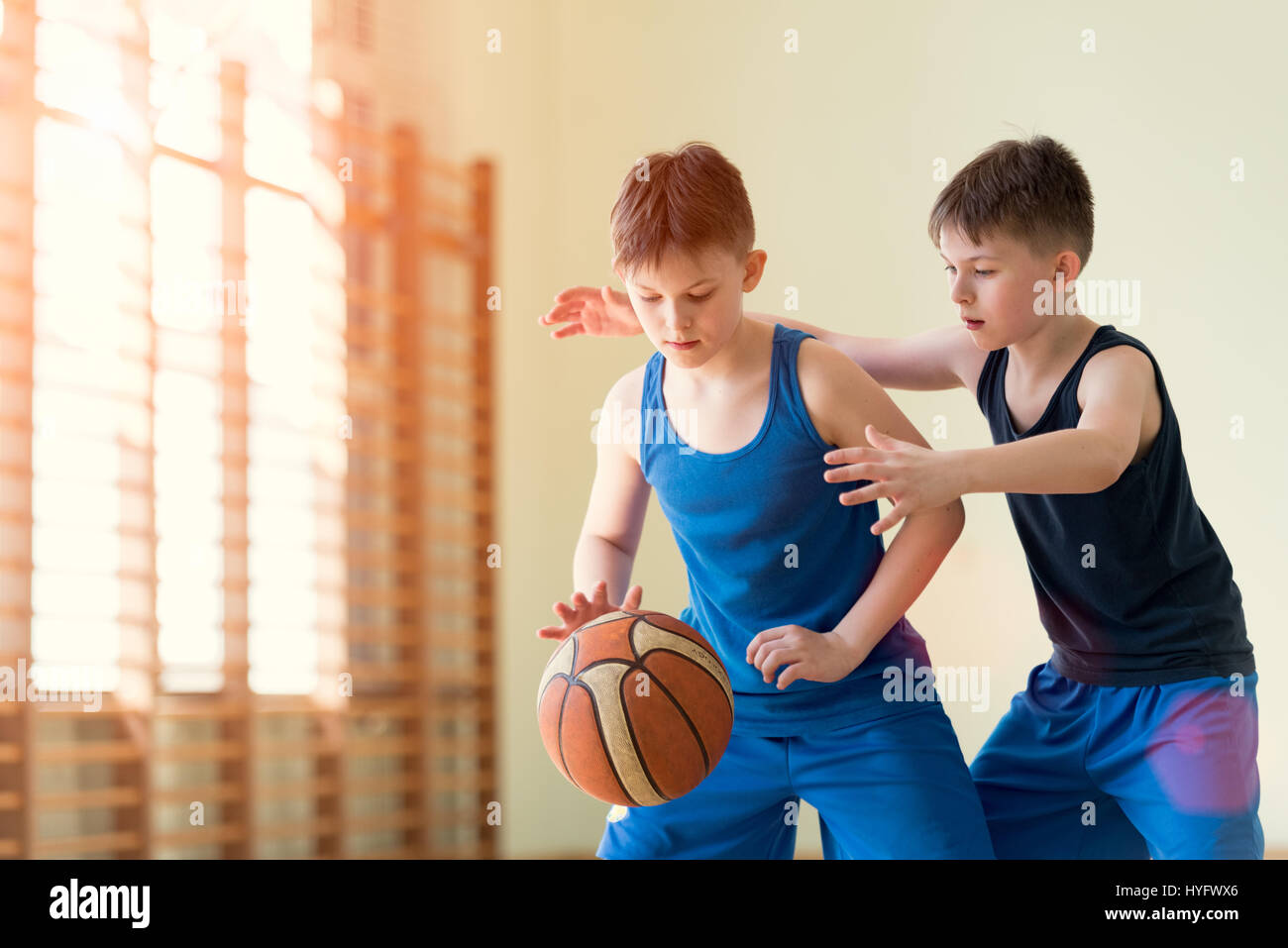 Boys Playing Basketball In Gym