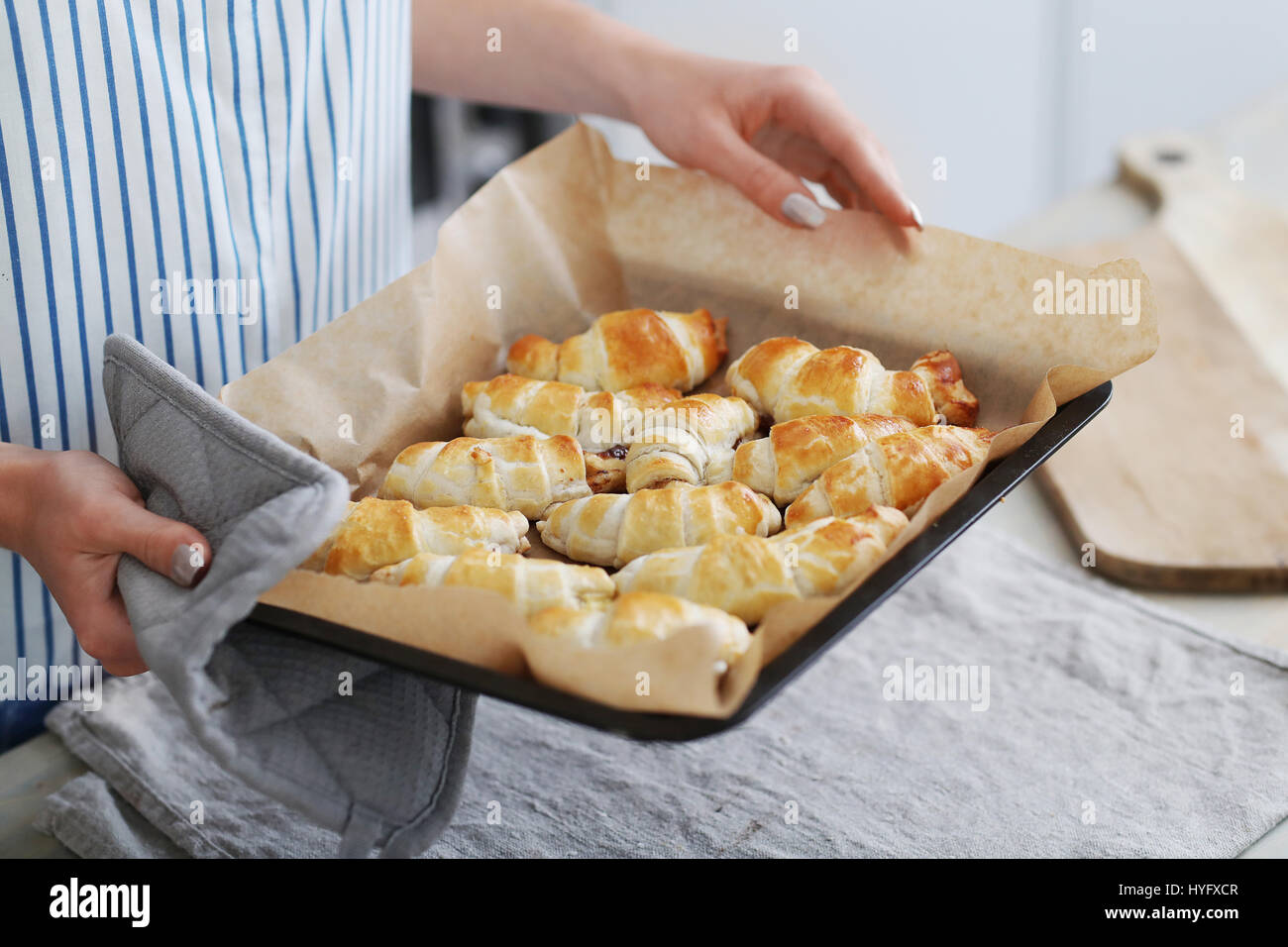 Food. Woman cooking croissants in kitchen Stock Photo - Alamy