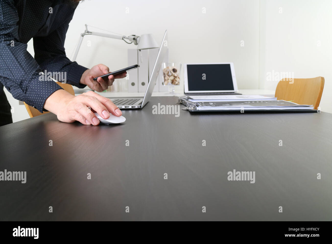 businessman or Designer using mouse and smart phone with latop and ...