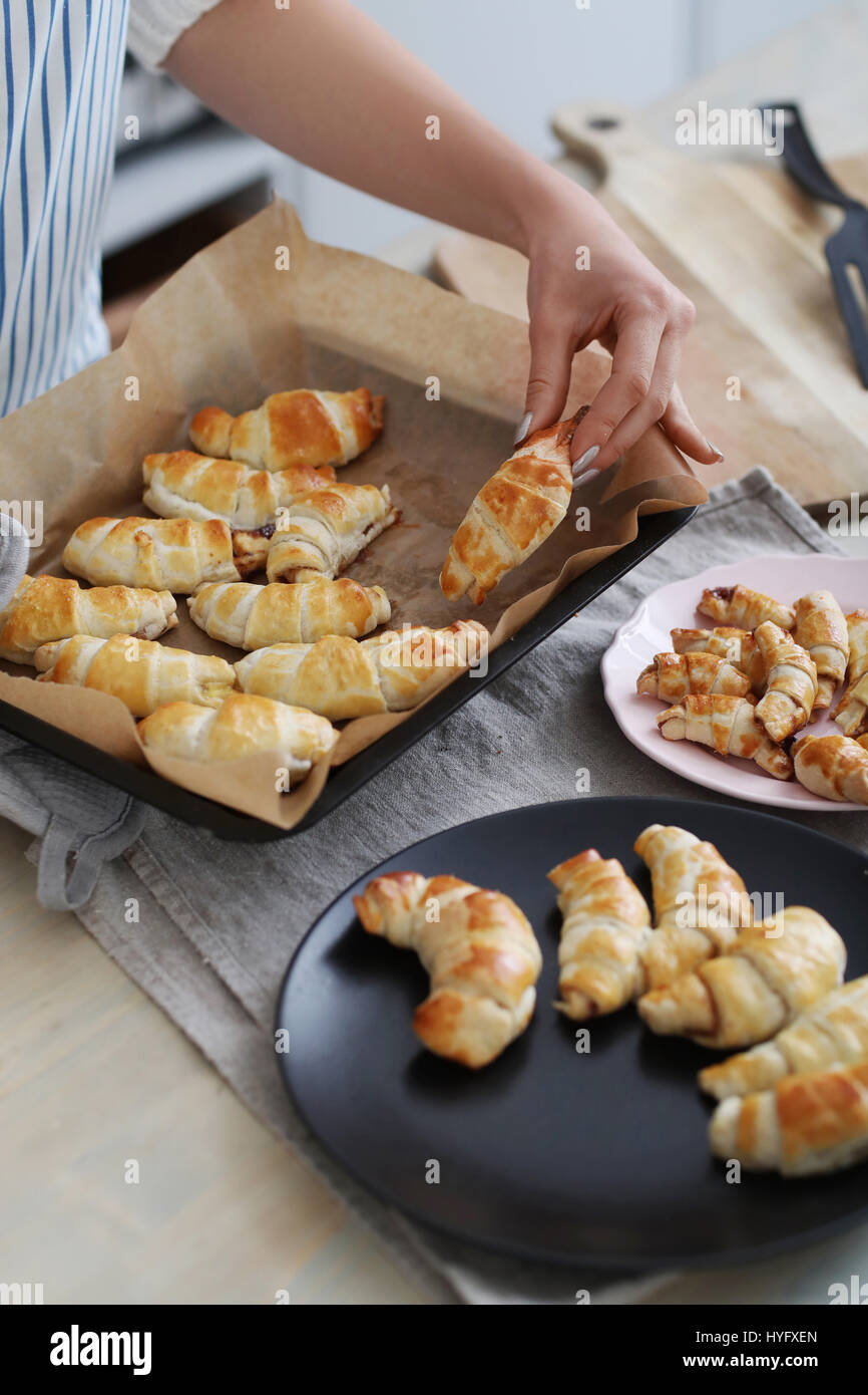 Food. Woman cooking croissants in kitchen Stock Photo - Alamy