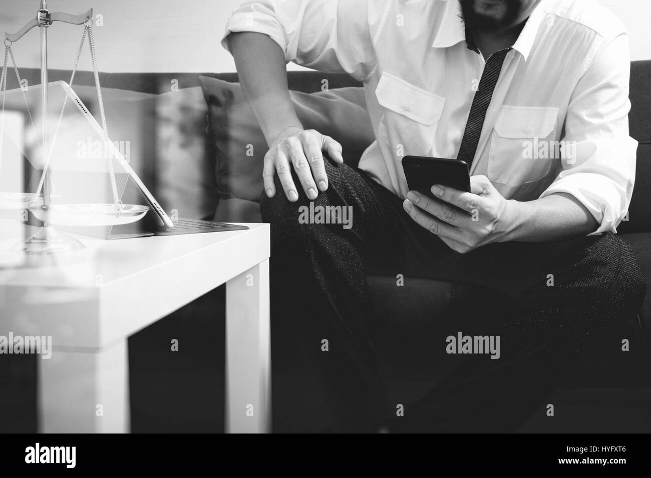 Justice and Law context.Male lawyer hand sitting on sofa and working ...