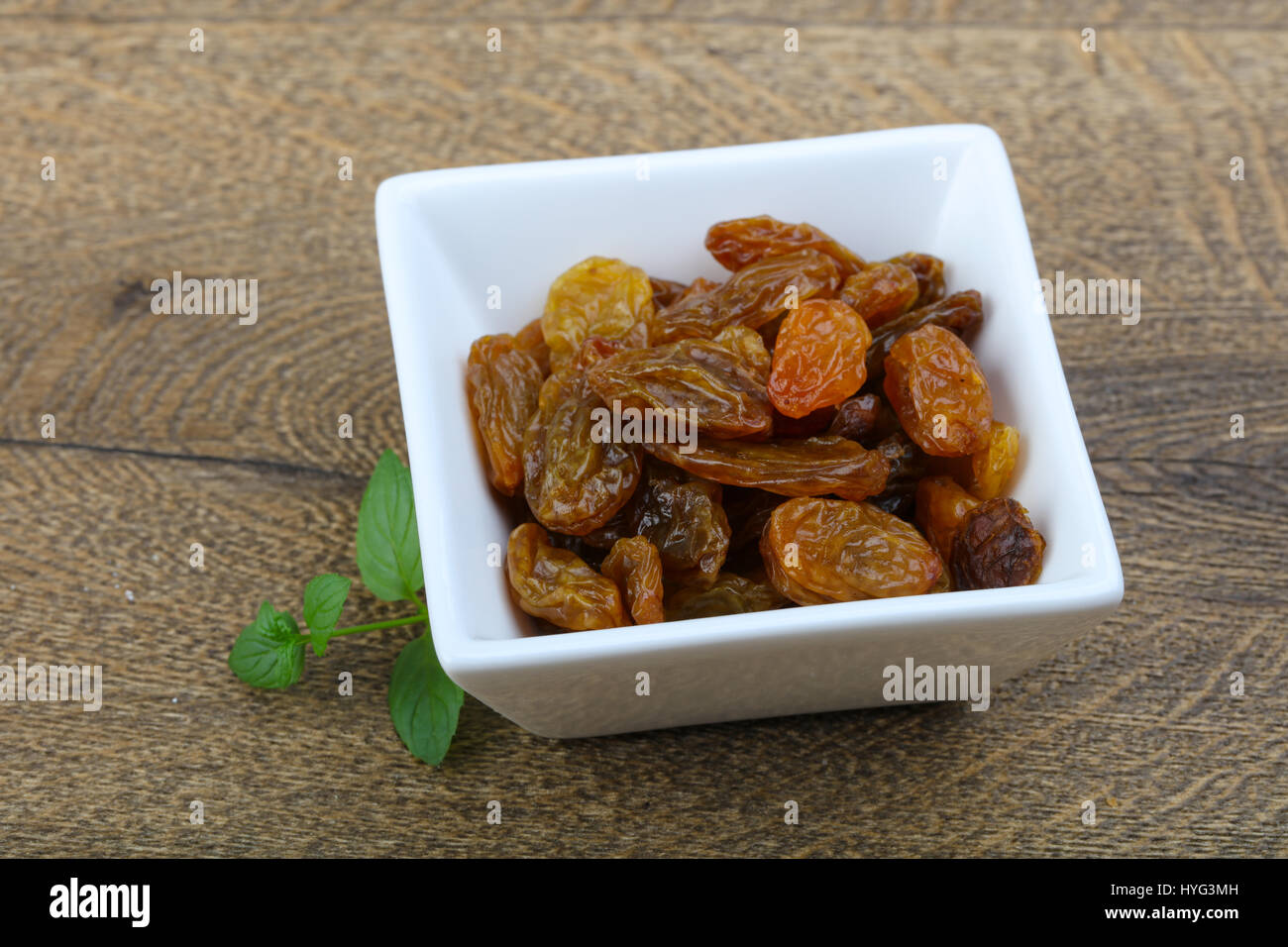 Sweet raisins in the bowl with mint leaves Stock Photo - Alamy