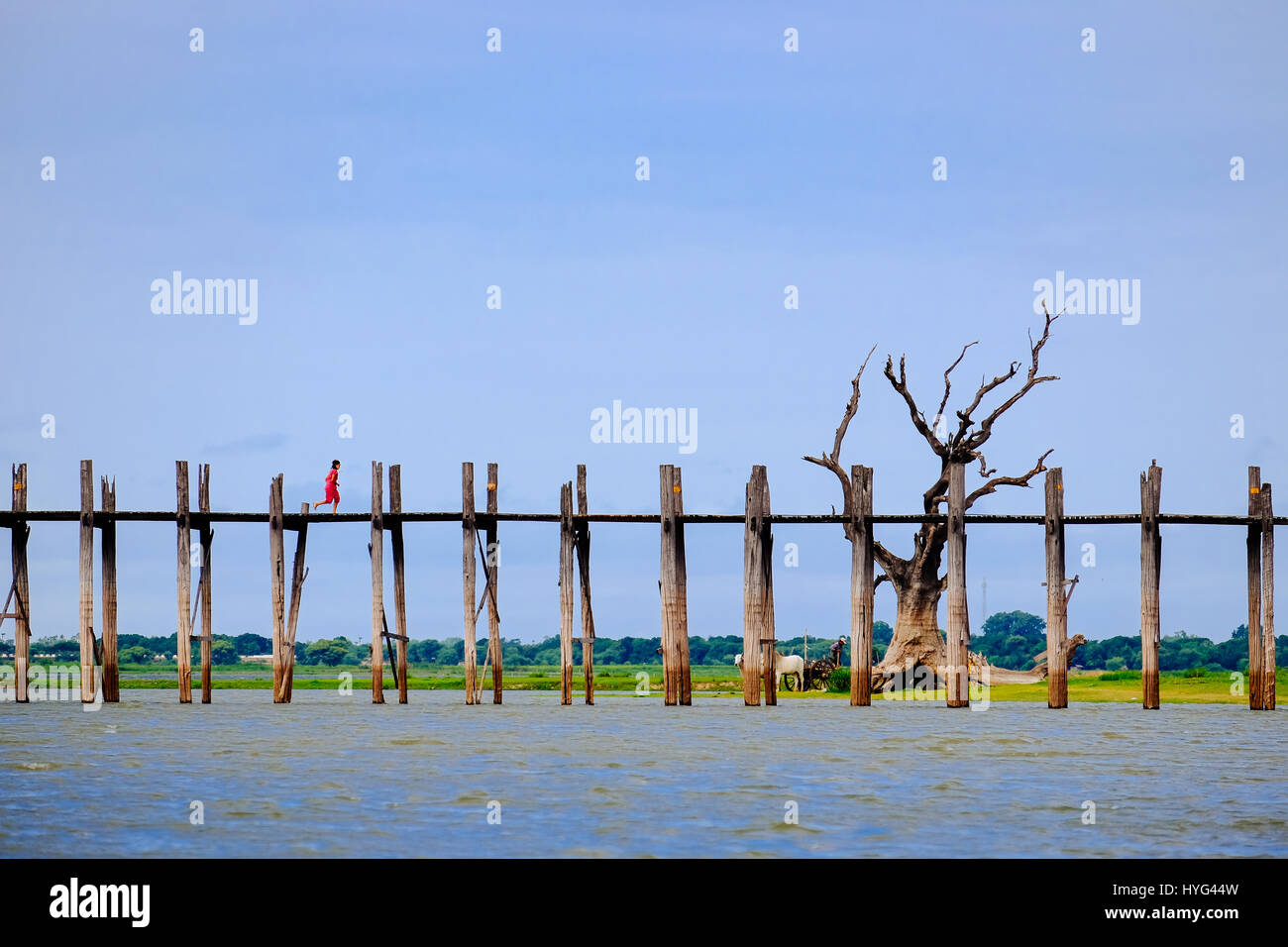 Amarapura, Myanmar - 28 June, 2015: Girl in colorful clothes running on ...