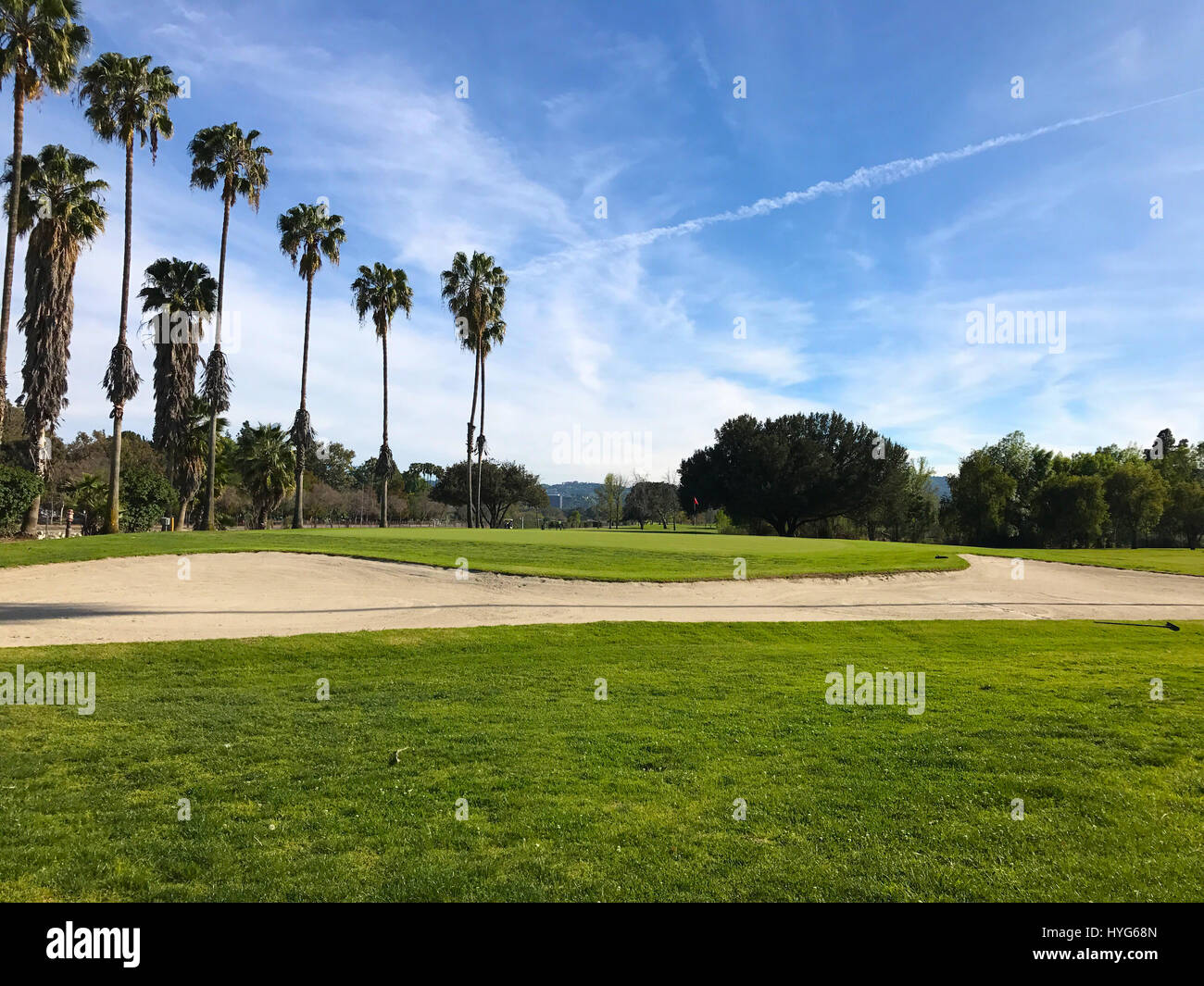 green golf field and blue cloudy sky. american landscape Stock Photo ...
