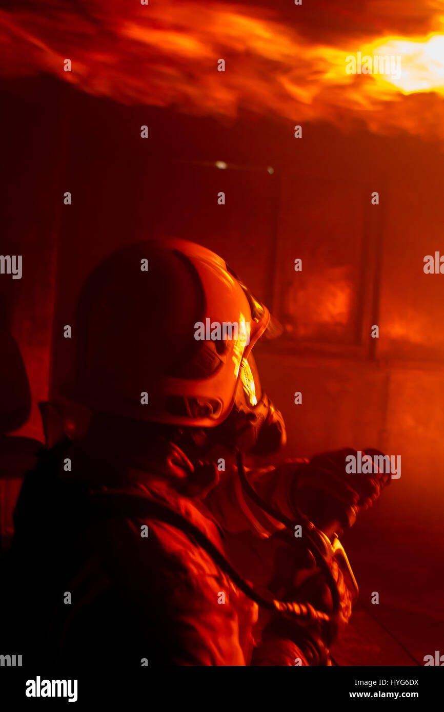 Firefighters carry out live fire training and cooling techniques Stock ...