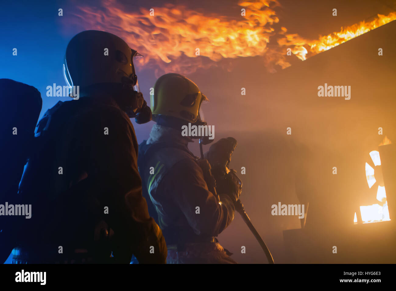 Firefighters carry out live fire training and cooling techniques Stock ...