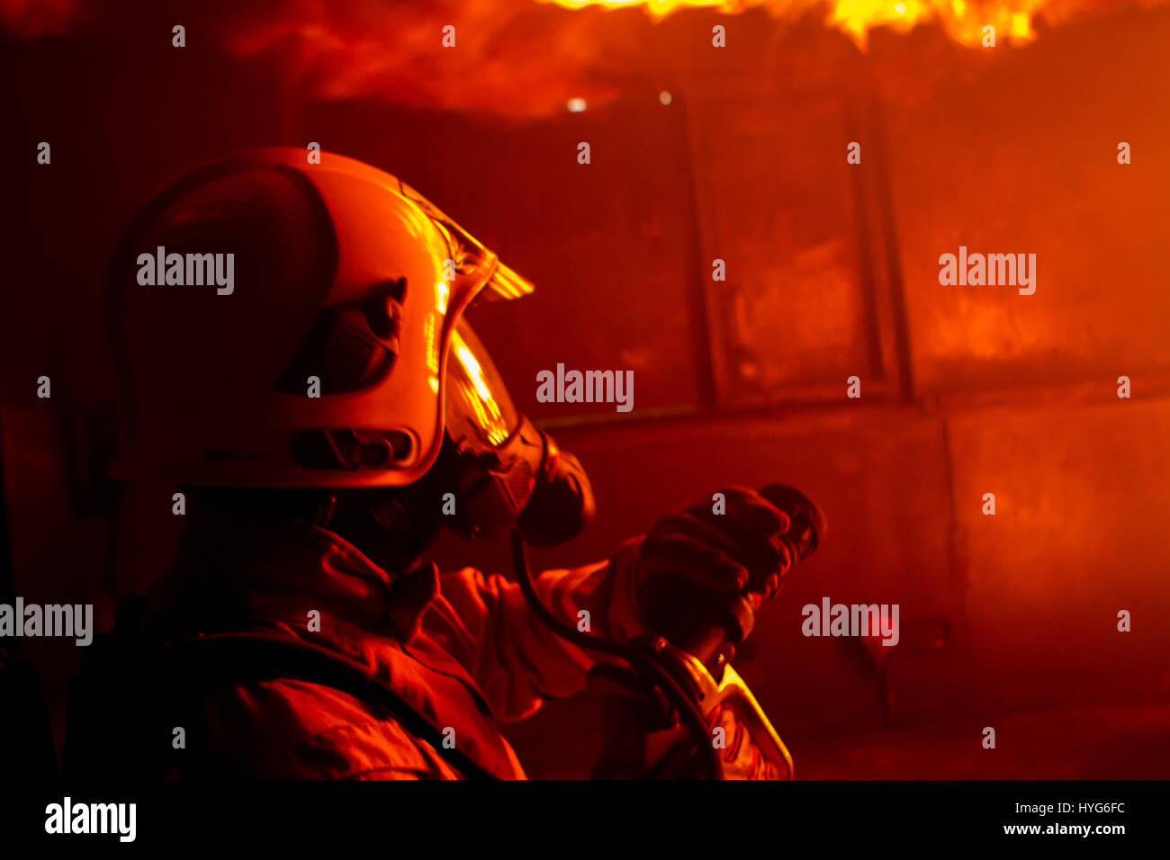 Firefighters carry out live fire training and cooling techniques Stock ...