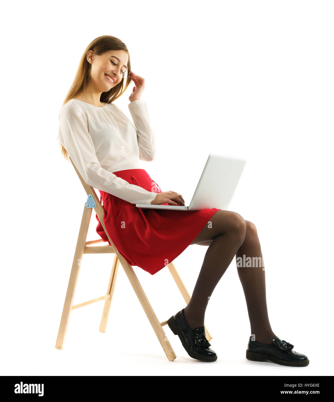 Young pretty student girl sitting on a chair with laptop Stock Photo ...