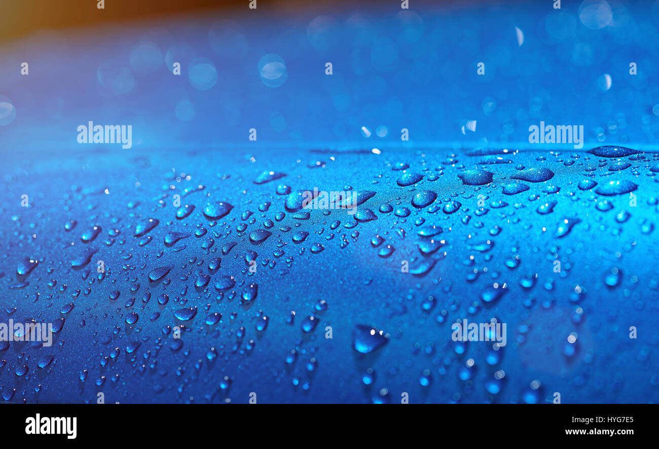 Water drops on car metal blue paint. Closeup of rain drops on blue ...
