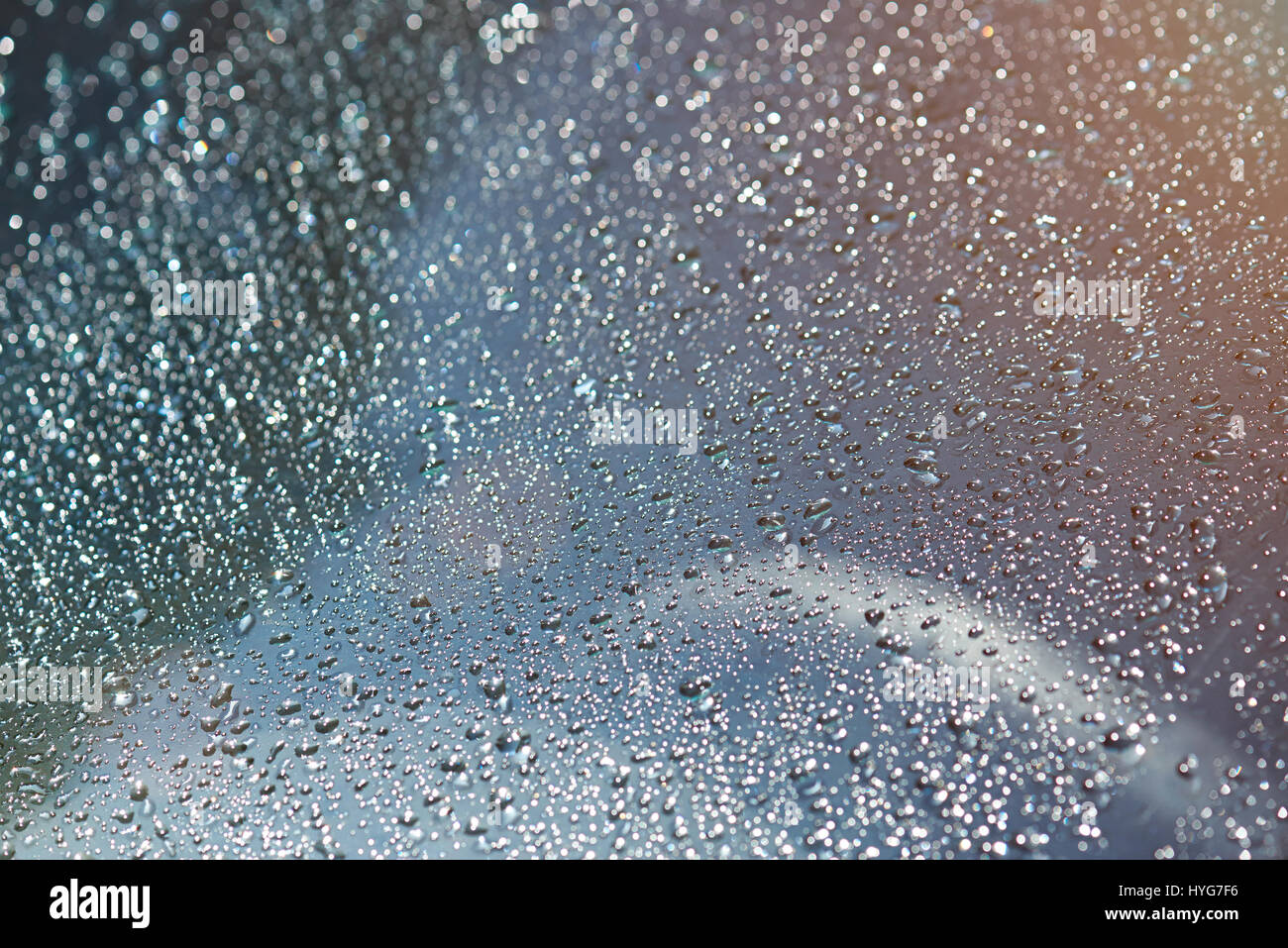 Rain drops on car windshield close-up. Water drops on front car window ...
