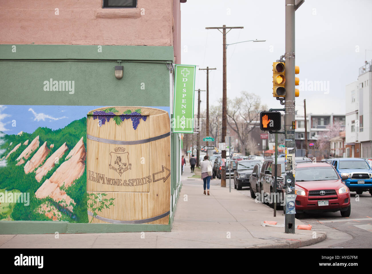 A green dispensary sign hangs outside of a Denver, Colorado dispensary ...