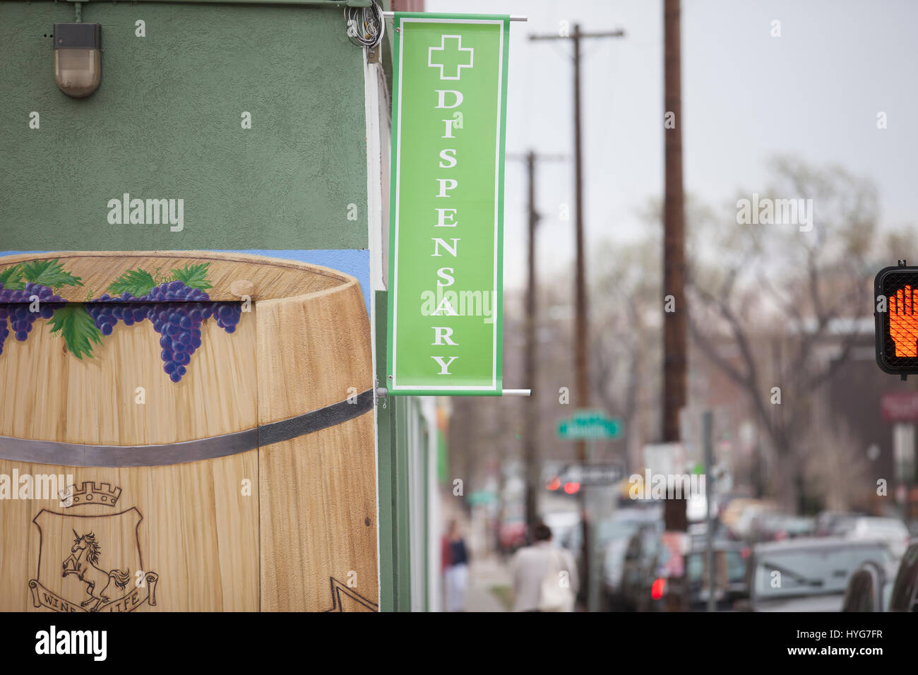 A green dispensary sign hangs outside of a Denver, Colorado dispensary ...