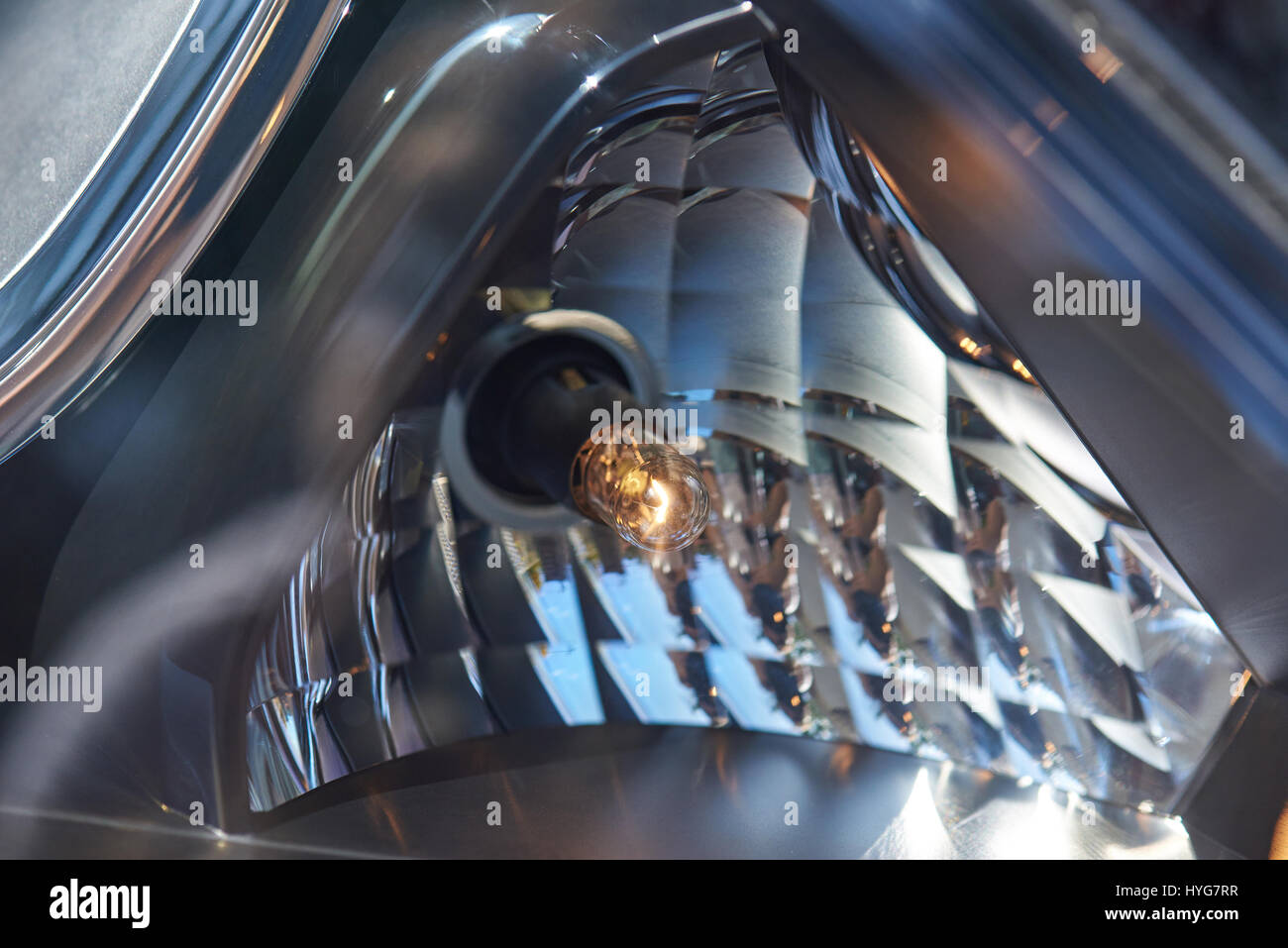 Closeup of light bulb in modern car. Yellow light from car head light ...