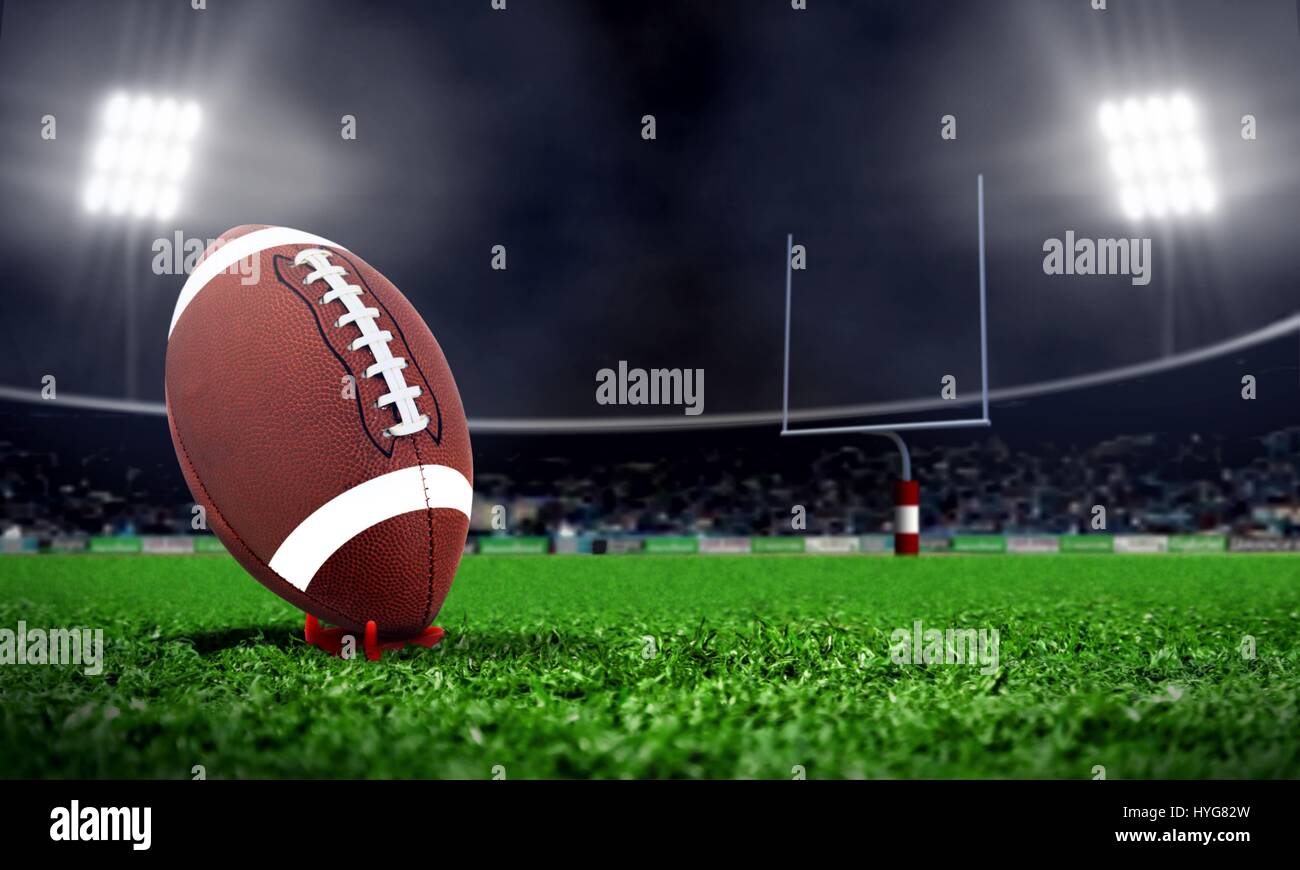 American football in stadium at night with spotlight Stock Photo - Alamy