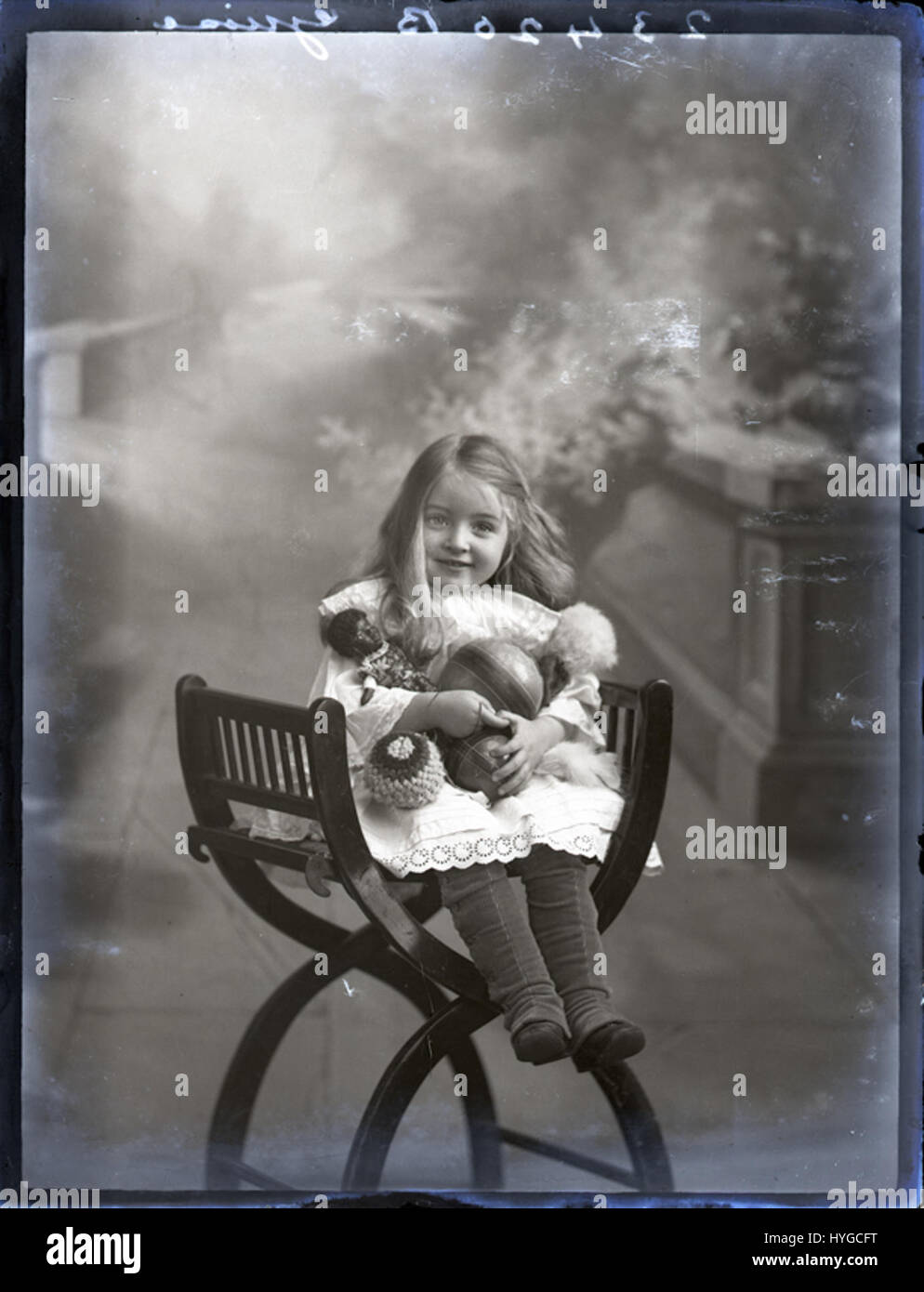 A photograph from 1908 titled 'Little girl Guise' captures a young girl ...