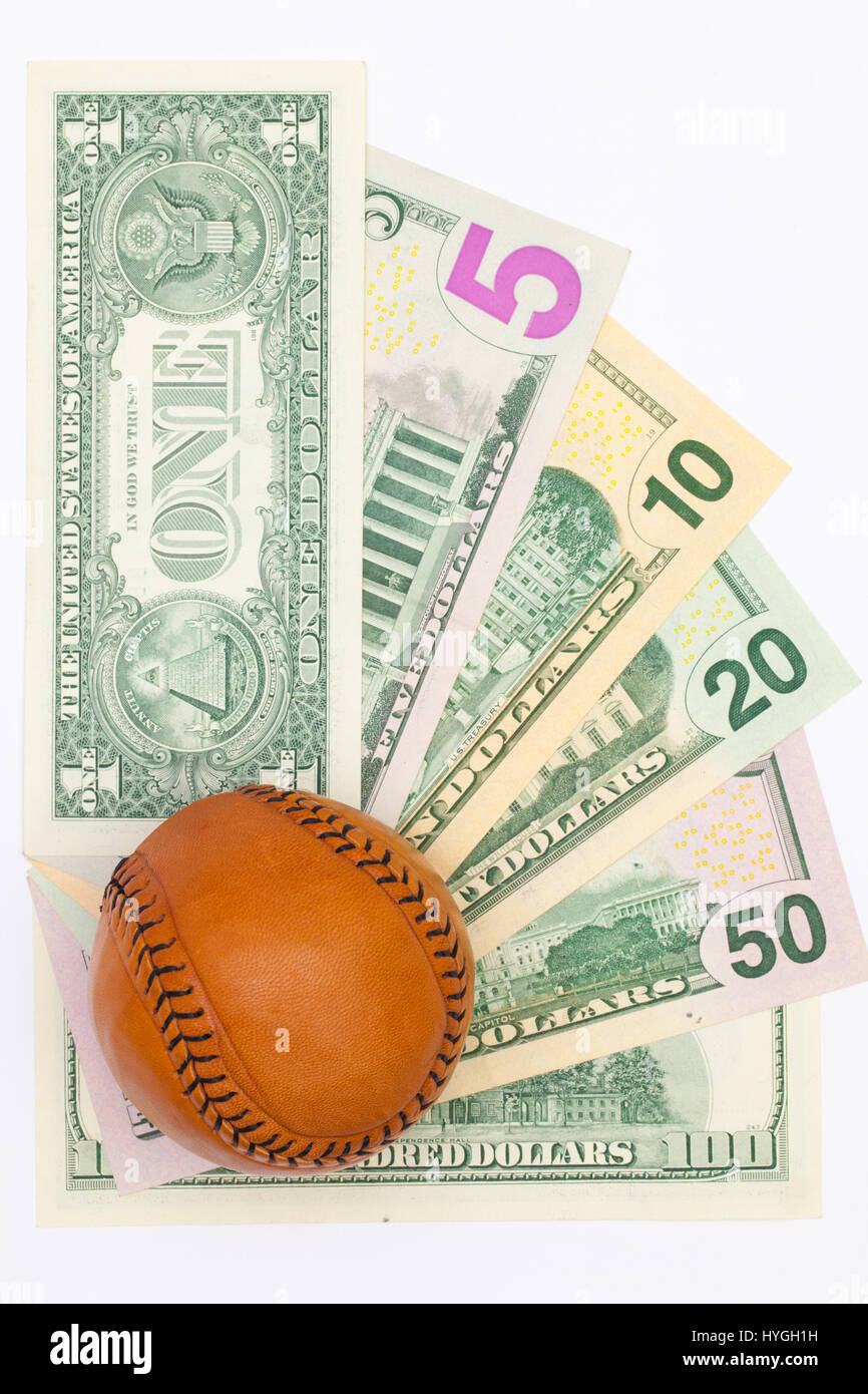 Leather baseball ball and us dollar banknotes on the white table. Flat ...