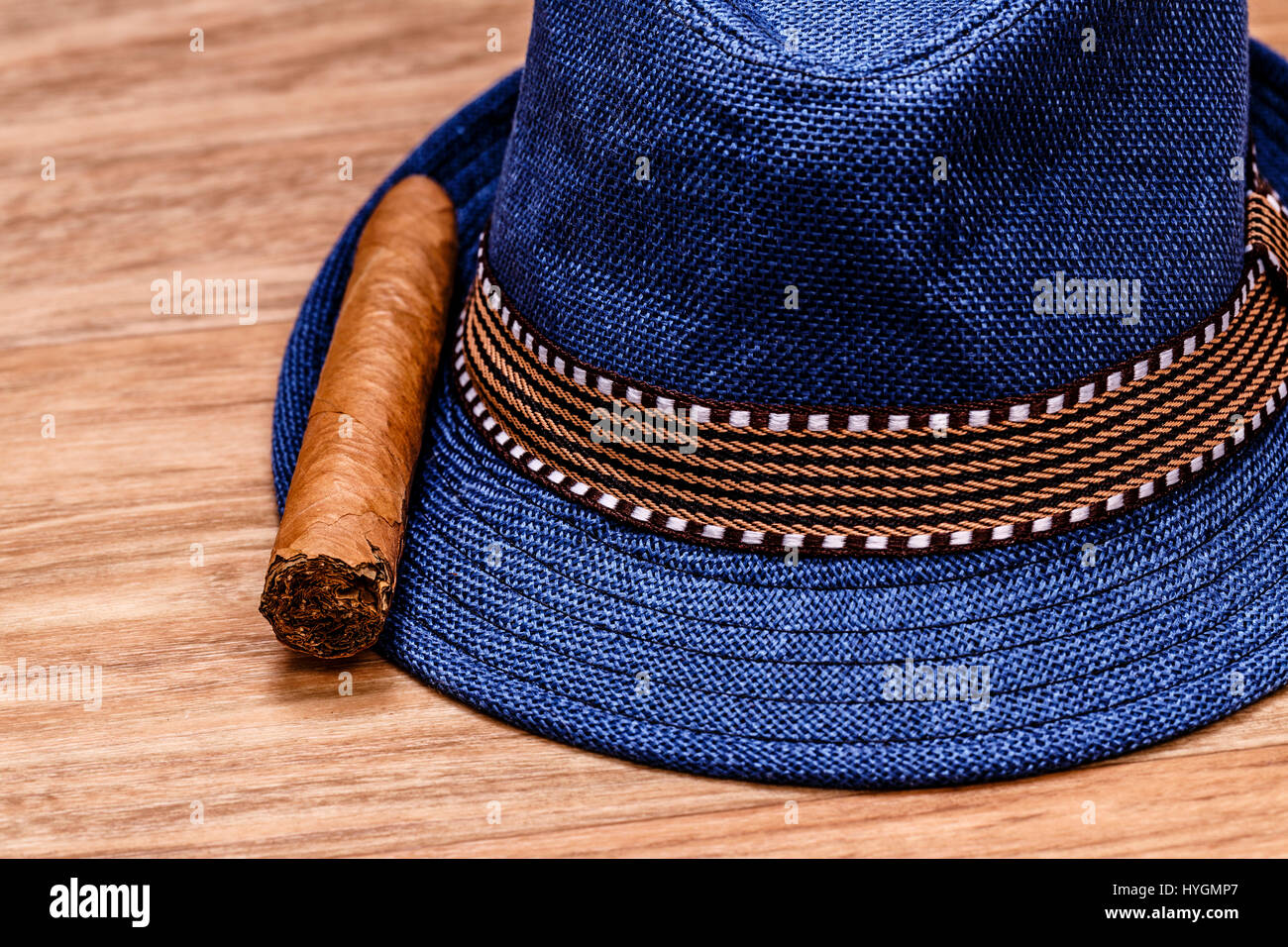 blue hat and cigar on wooden floor, smoke relax concept Stock Photo - Alamy