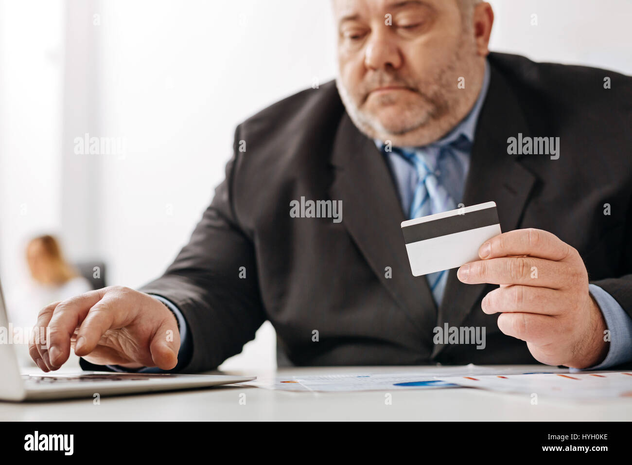 Concerned chubby guy checking his bank account Stock Photo - Alamy