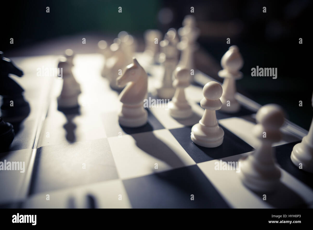 Image of the white pieces on a chess board, with shallow depth of field ...