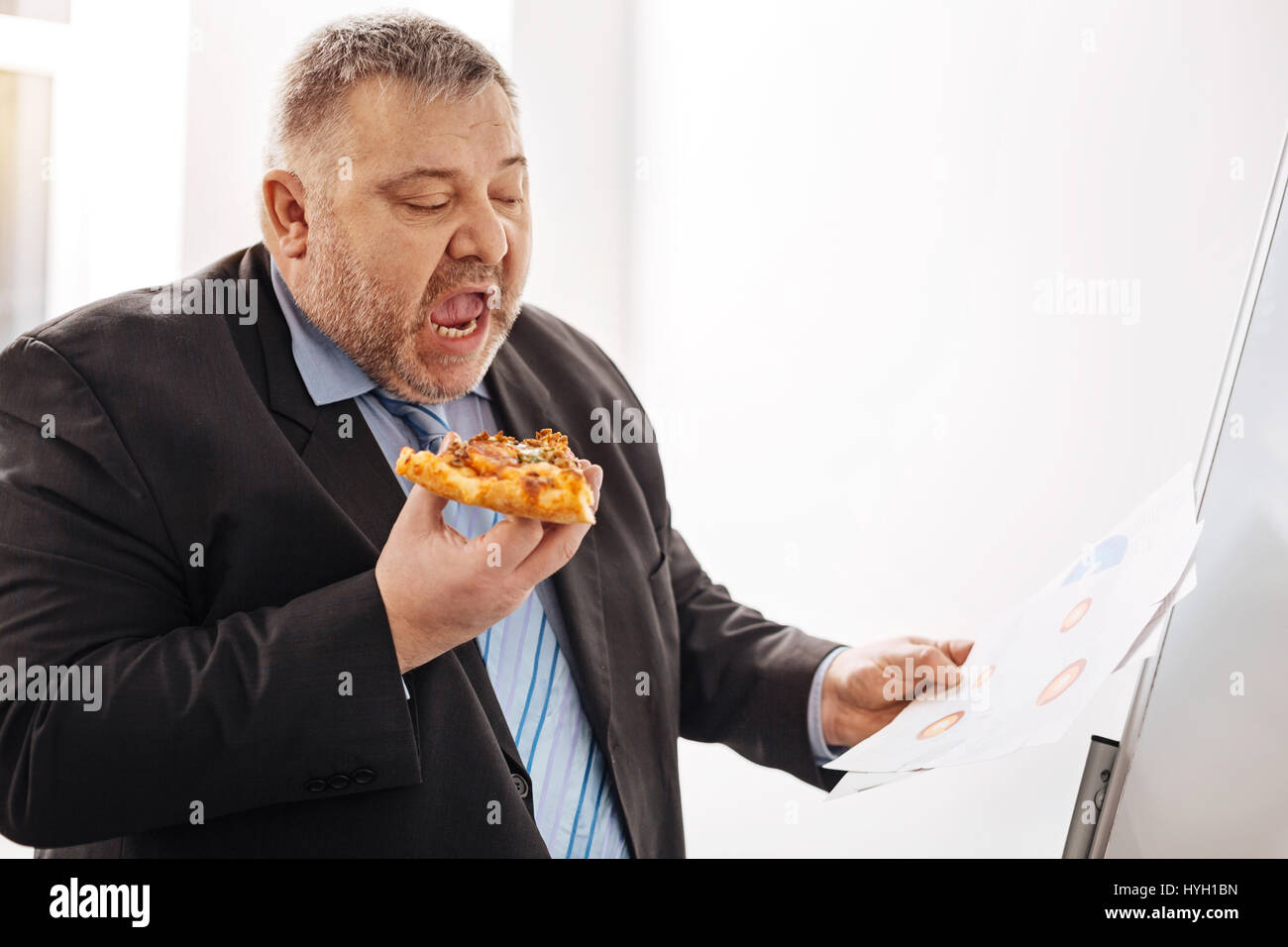 Overwhelmed busy man multitasking at work Stock Photo - Alamy